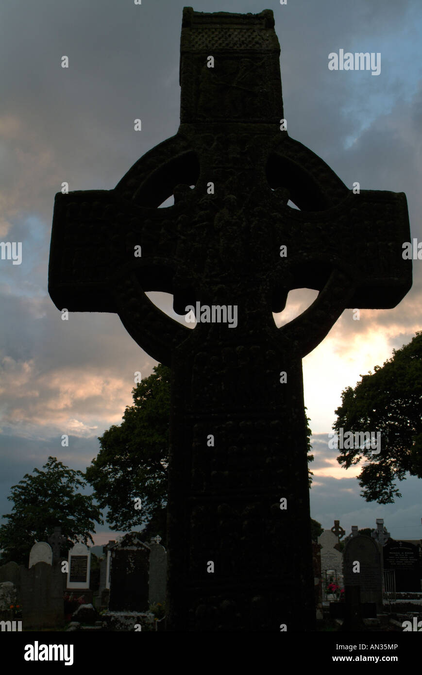 Sunset silhouette of the Cross of Muiredach a famous 10th century wheel ...