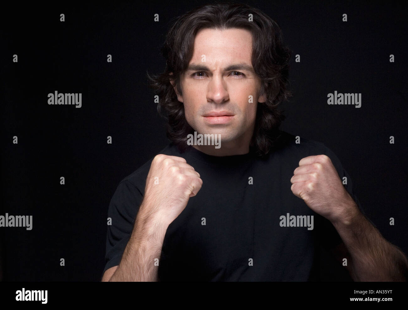 Portrait of man holding fists up Stock Photo - Alamy