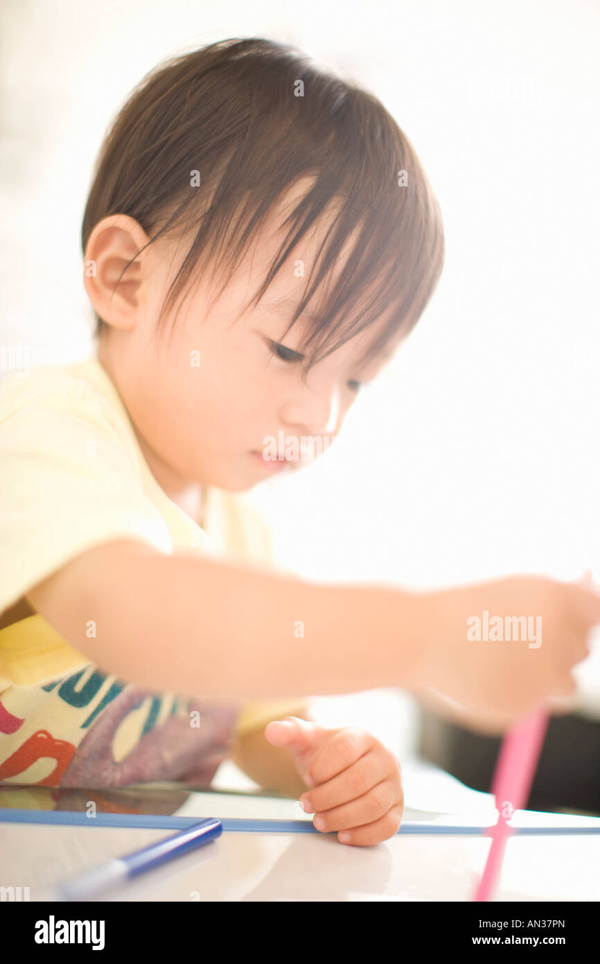 Japanese infant doing drawing Stock Photo - Alamy