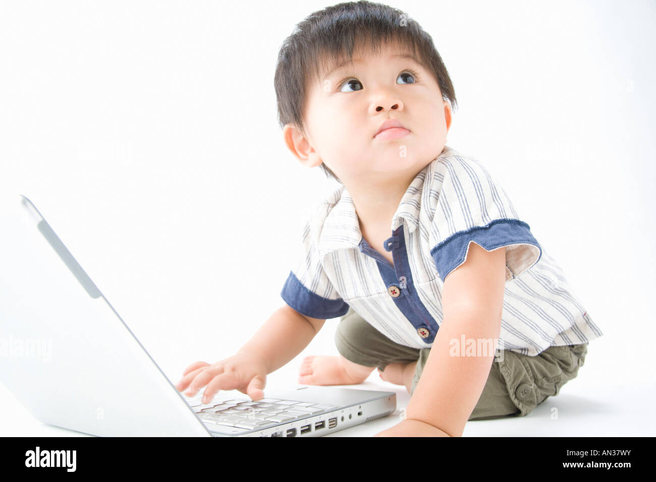 Boy operating laptop hi-res stock photography and images - Alamy