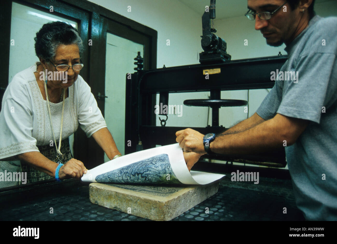 Artist making lithograph on printing hi-res stock photography and ...