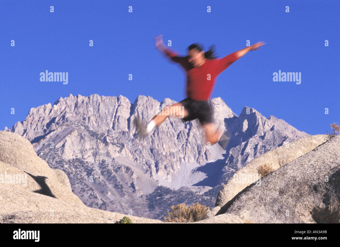 Man Jumping Over Rocks Stock Photo - Alamy