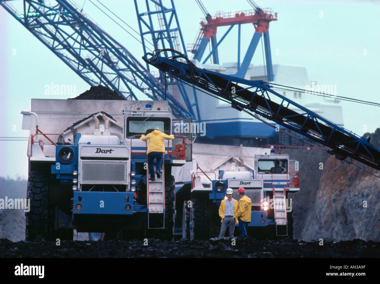 Electric powered Drag line and haul trucks mining coal in open pit mine ...