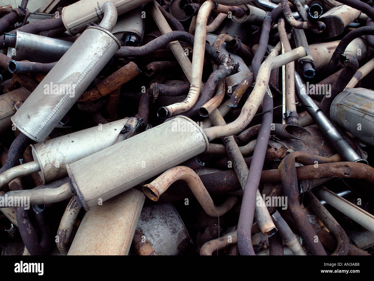 A pile of rusty old mufflers in a land fill Stock Photo - Alamy