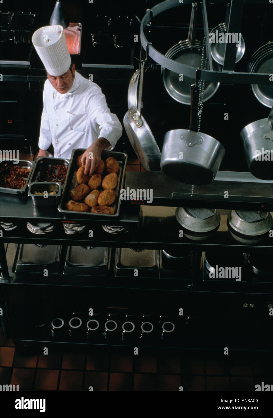 Head chef cooking in commercial kitchen Stock Photo - Alamy