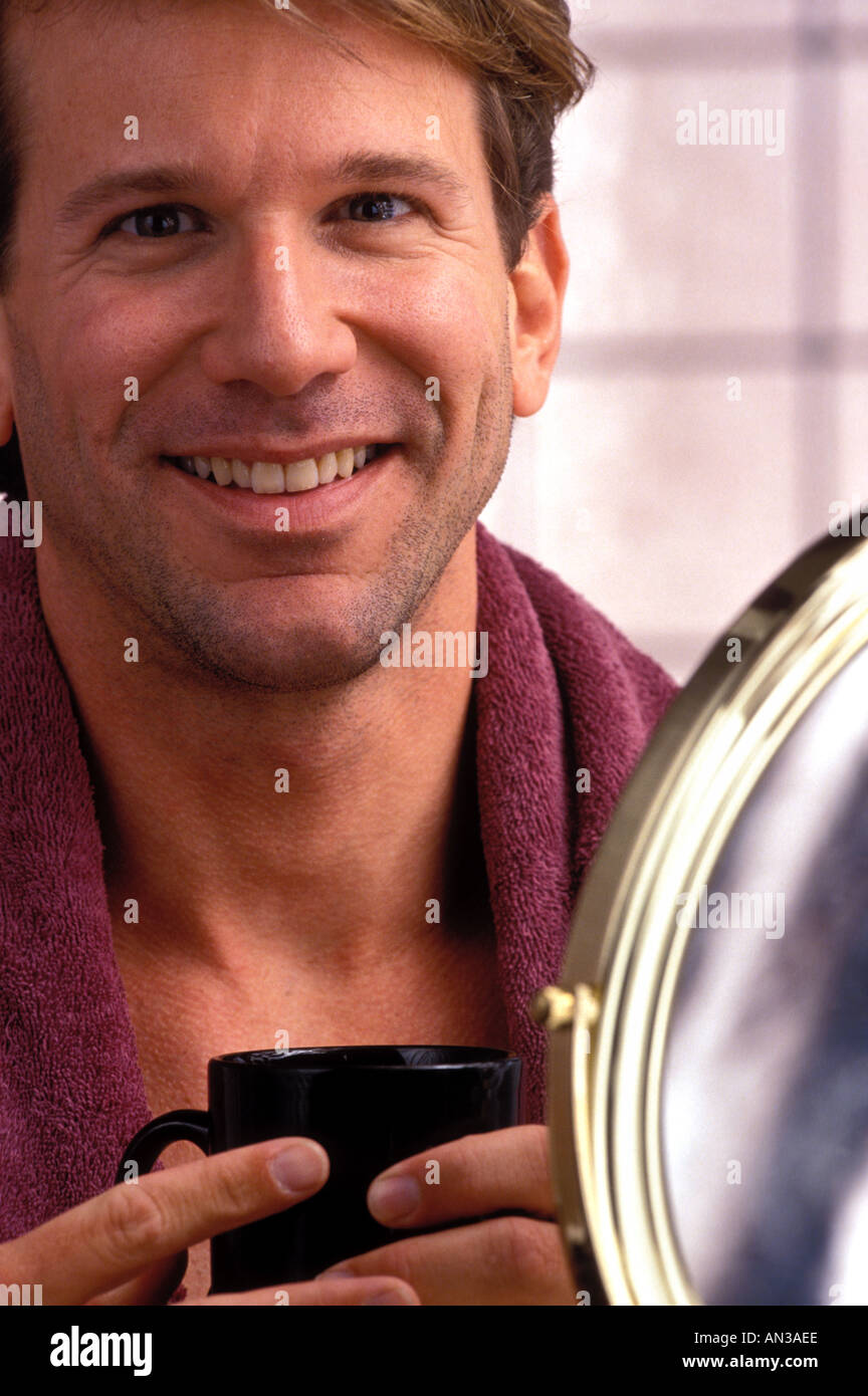 Man injoying coffee after shaving in mirror Stock Photo - Alamy