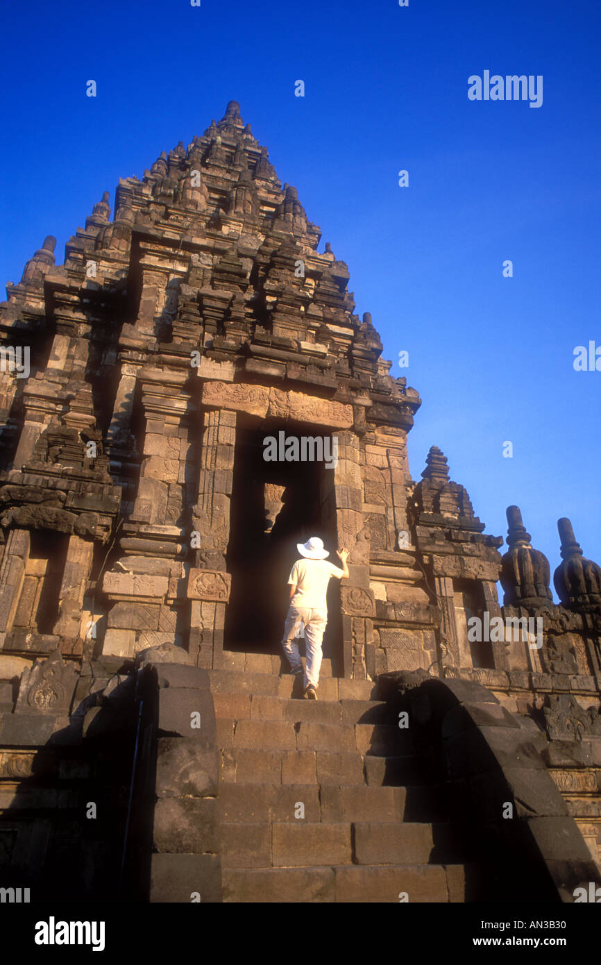 Woman climbing steps at the Prambanan temple complex in central Java ...