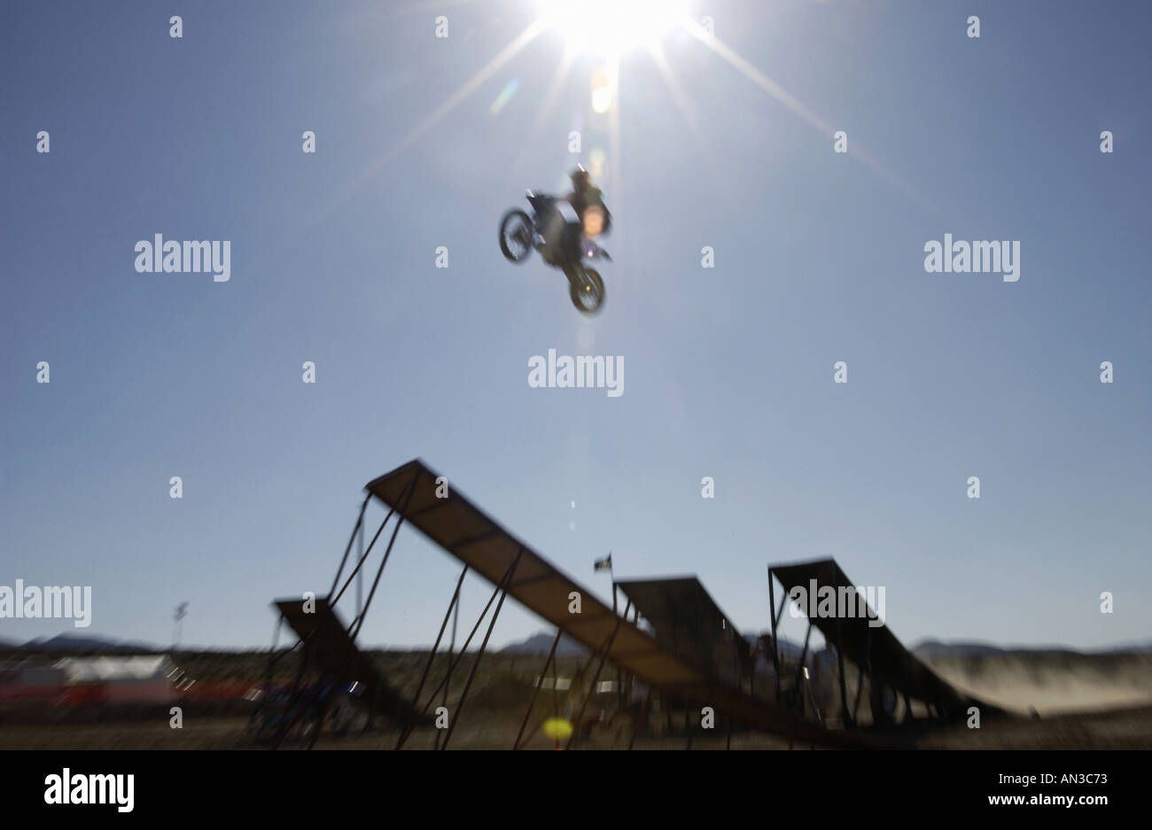 Motocross riders jumping a ramp Stock Photo - Alamy