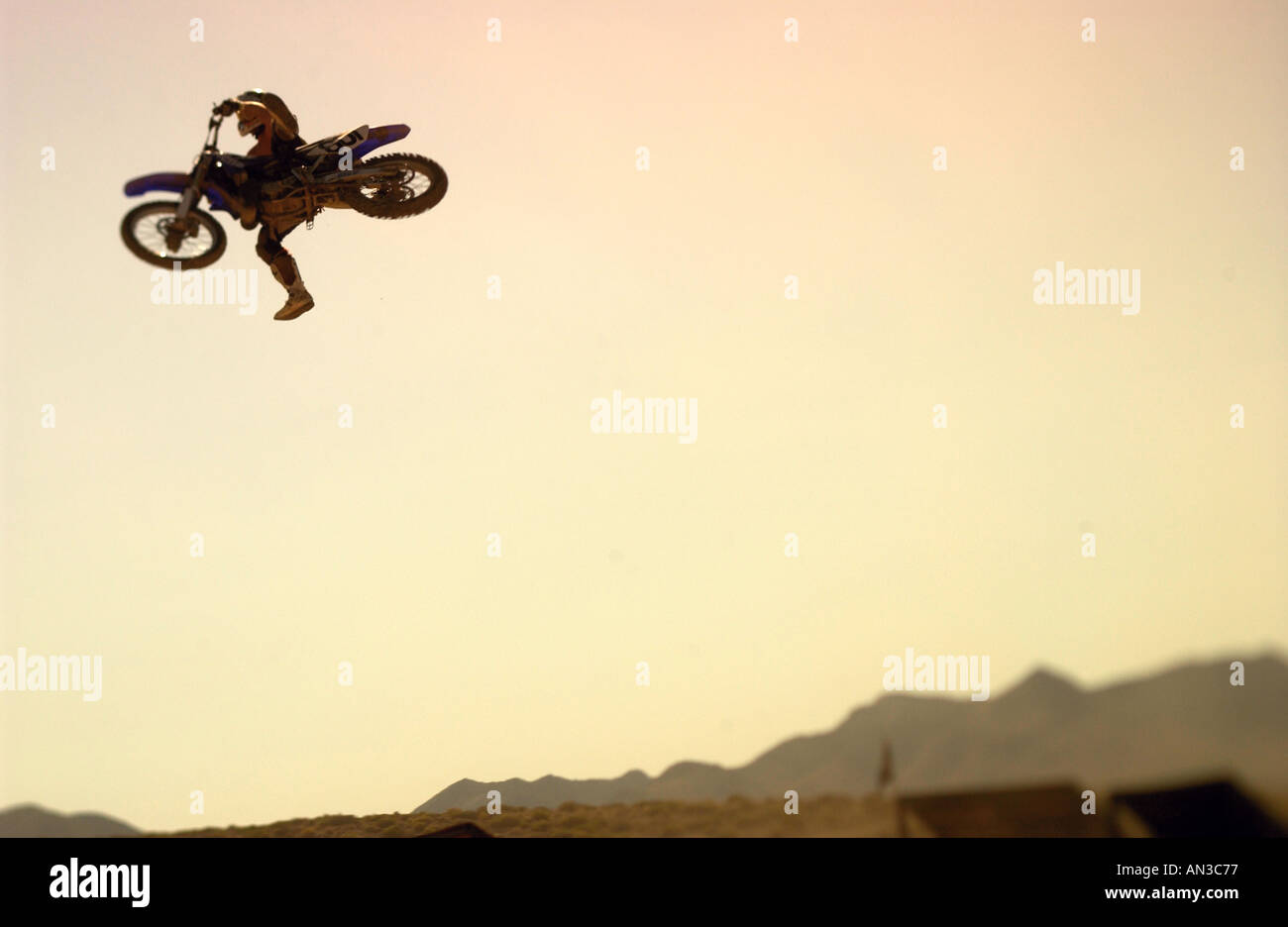 Motocross riders jumping a ramp Stock Photo - Alamy
