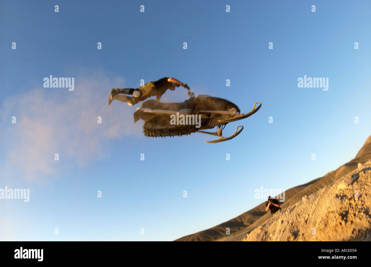 A snowmobiler riding in the dirt Stock Photo - Alamy