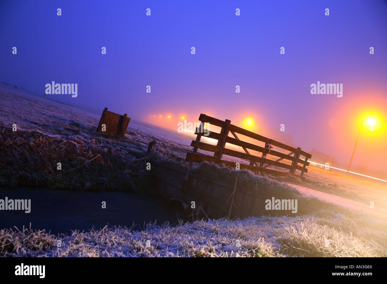 Dutch cold winter landscape with road and fence near Leiden, South ...