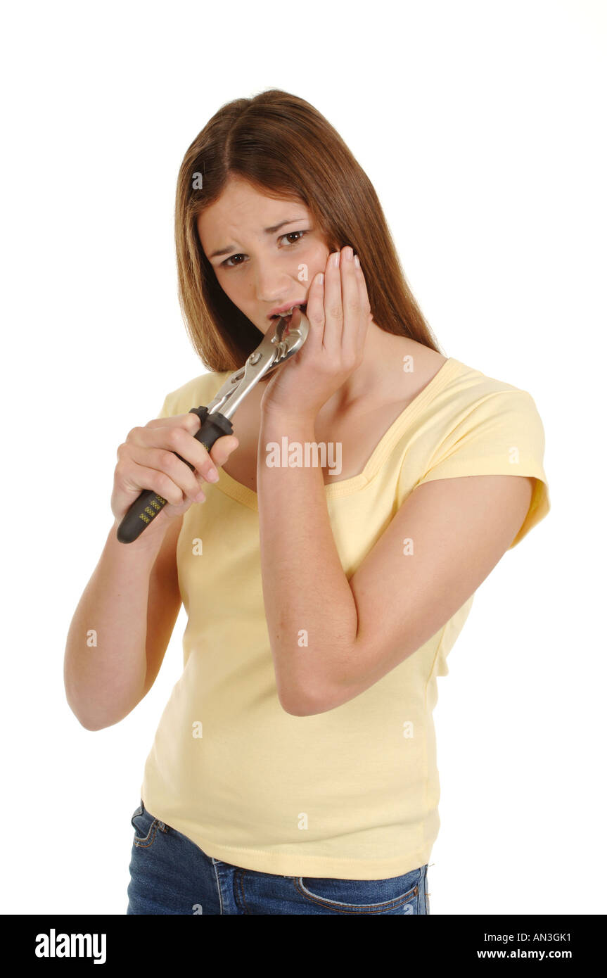 a teenage girl with toothache pulling her teeth out with a pair of ...