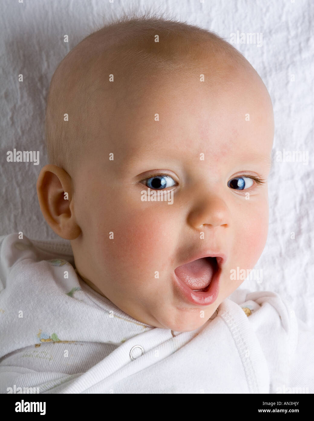 Healthy infant looking at camera Stock Photo - Alamy