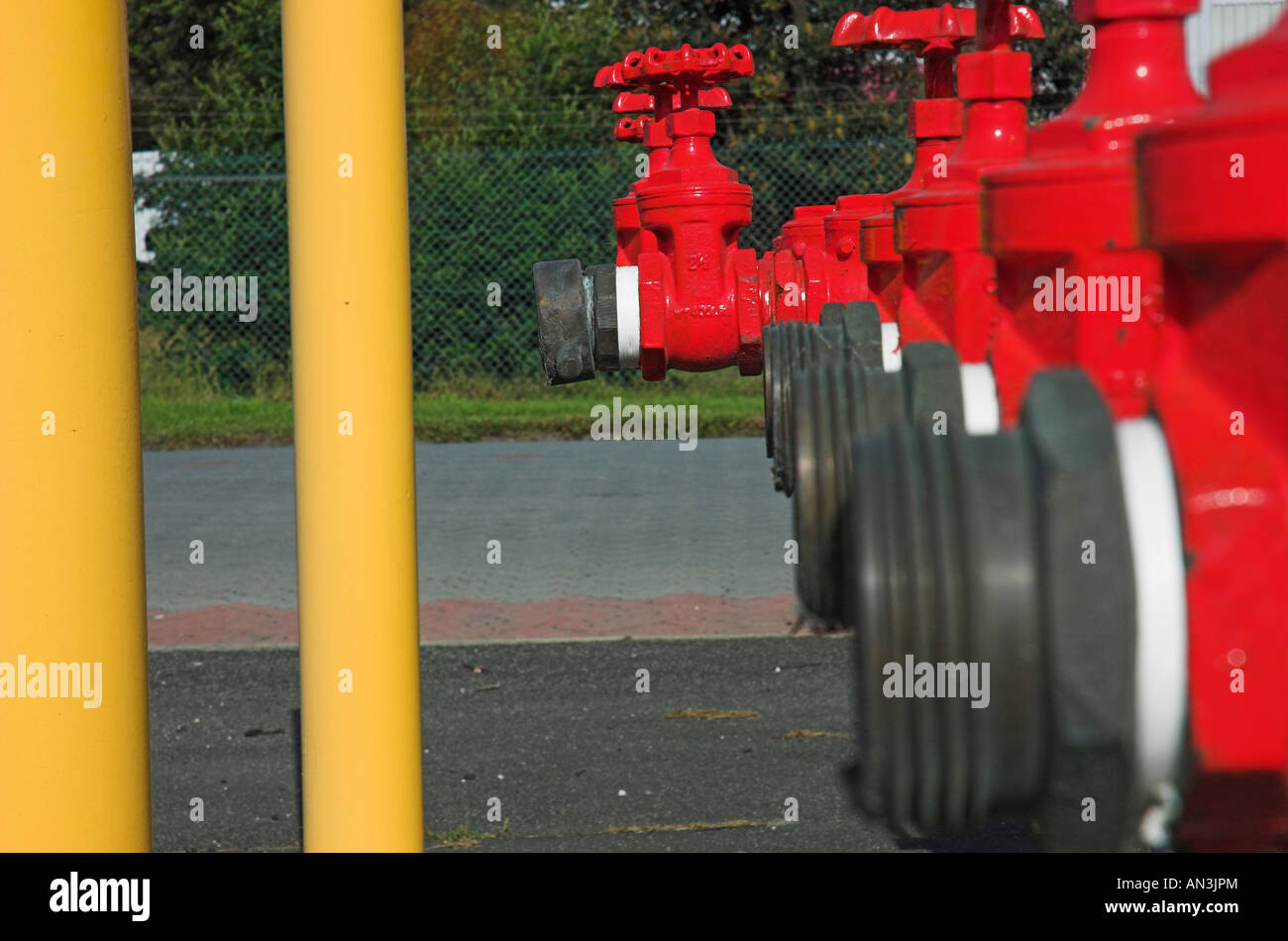 Red fire hydrants at industrial site Stock Photo - Alamy