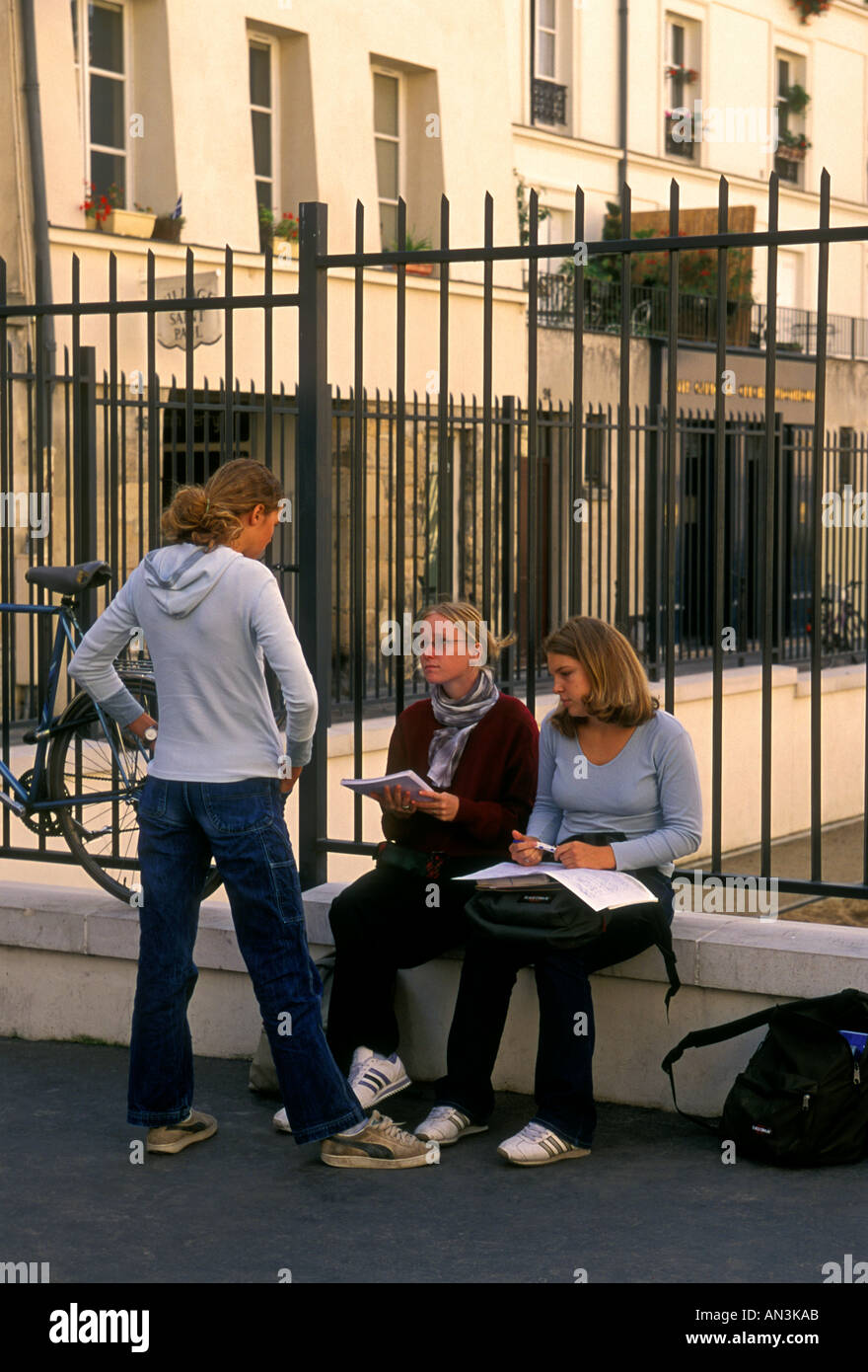 French teenage high school students studying for test during recess at ...