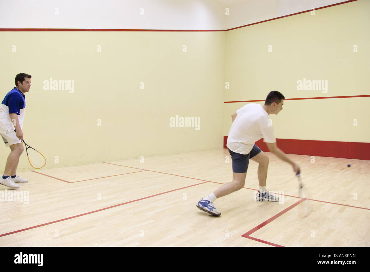 Two people playing squash Stock Photo - Alamy
