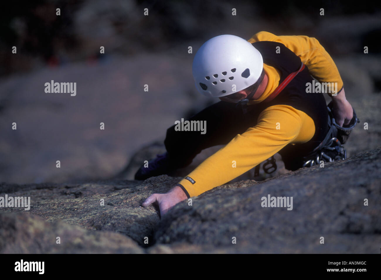 Man climbing a steep rock face Stock Photo - Alamy