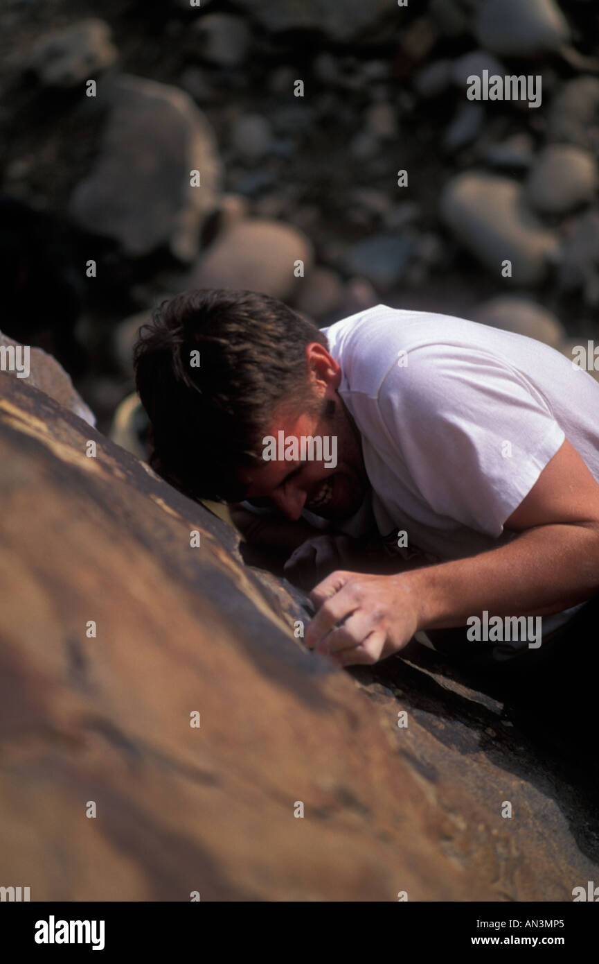 Rock climber struggling up a difficult climb Stock Photo - Alamy