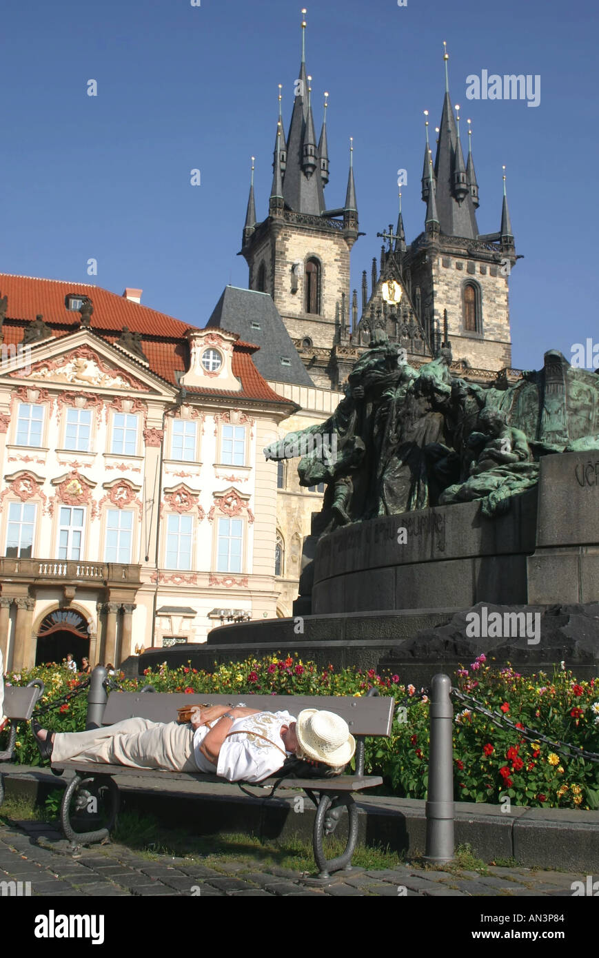 Tired tourist taking a break on a bench in the Old Town Square, Prague ...