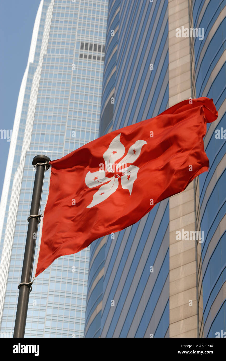 Hong Kong flag flying with IFC building behind Stock Photo - Alamy