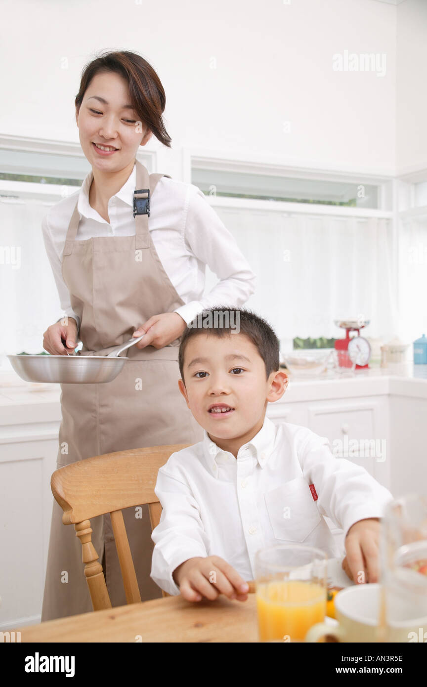 Mother cooking breakfast Stock Photo - Alamy