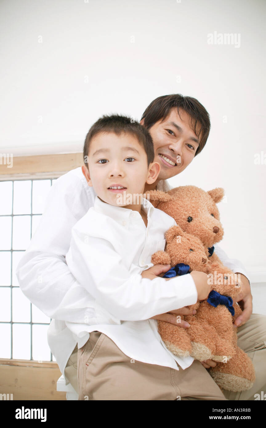 Father and son holding teddy bears Stock Photo - Alamy