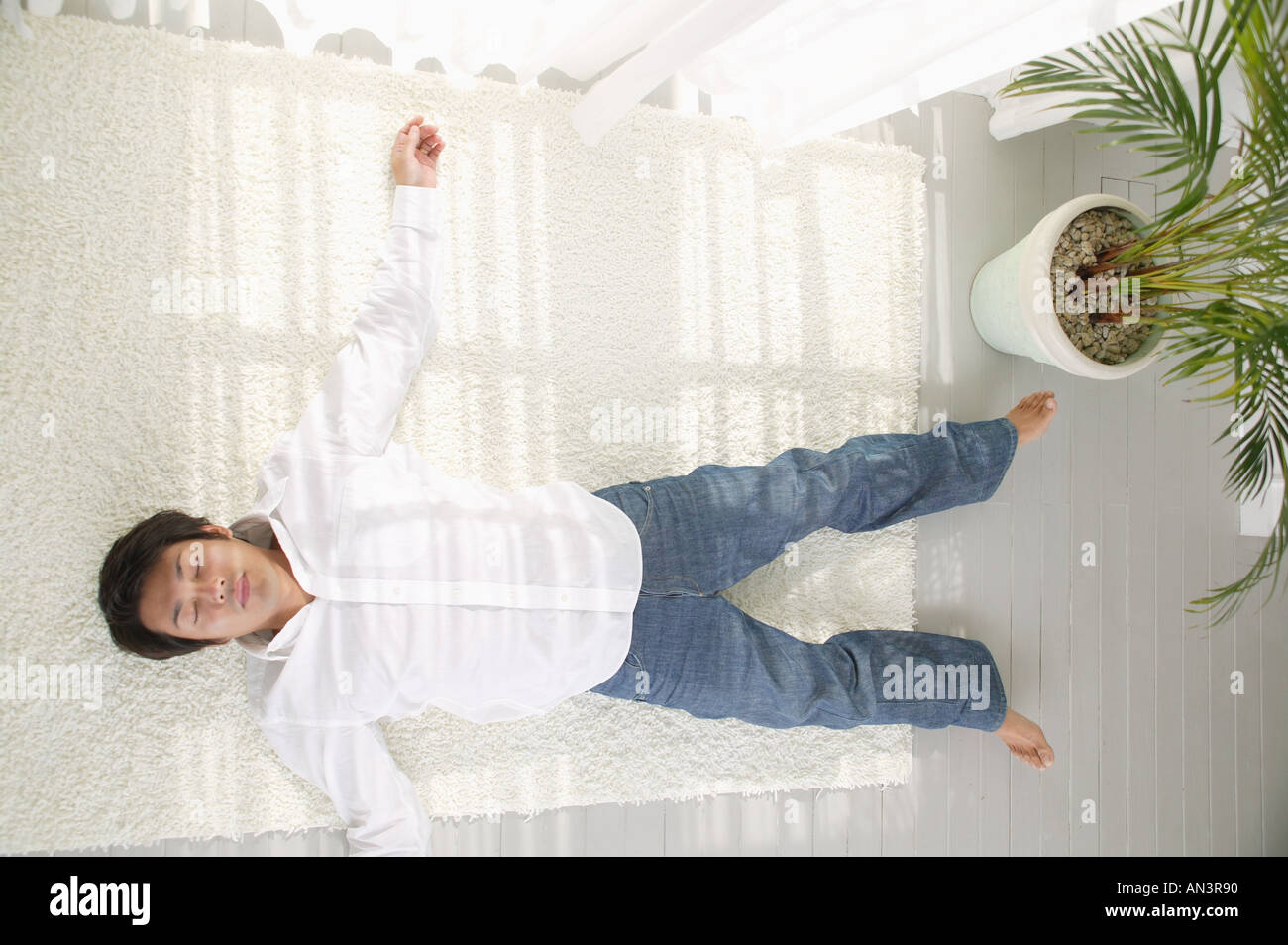 A mid adult man lying on floor Stock Photo - Alamy