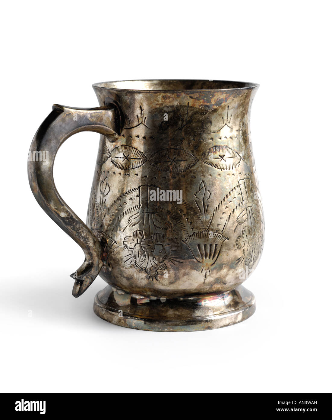 Antique vintage silver tankard close up with a decorative pattern on it ...