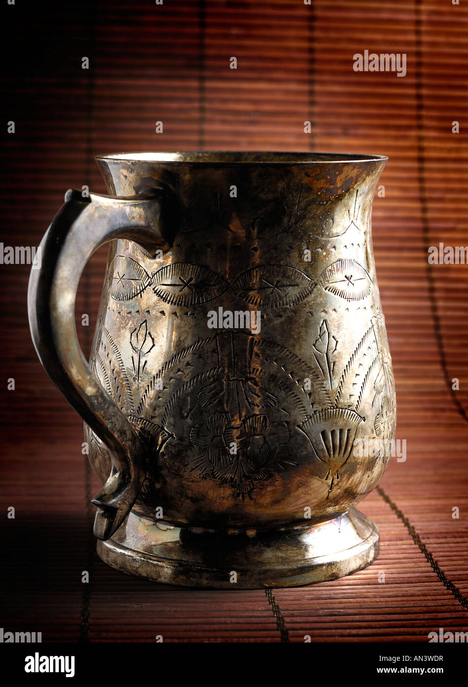 Antique vintage silver tankard close up with a decorative pattern on it ...