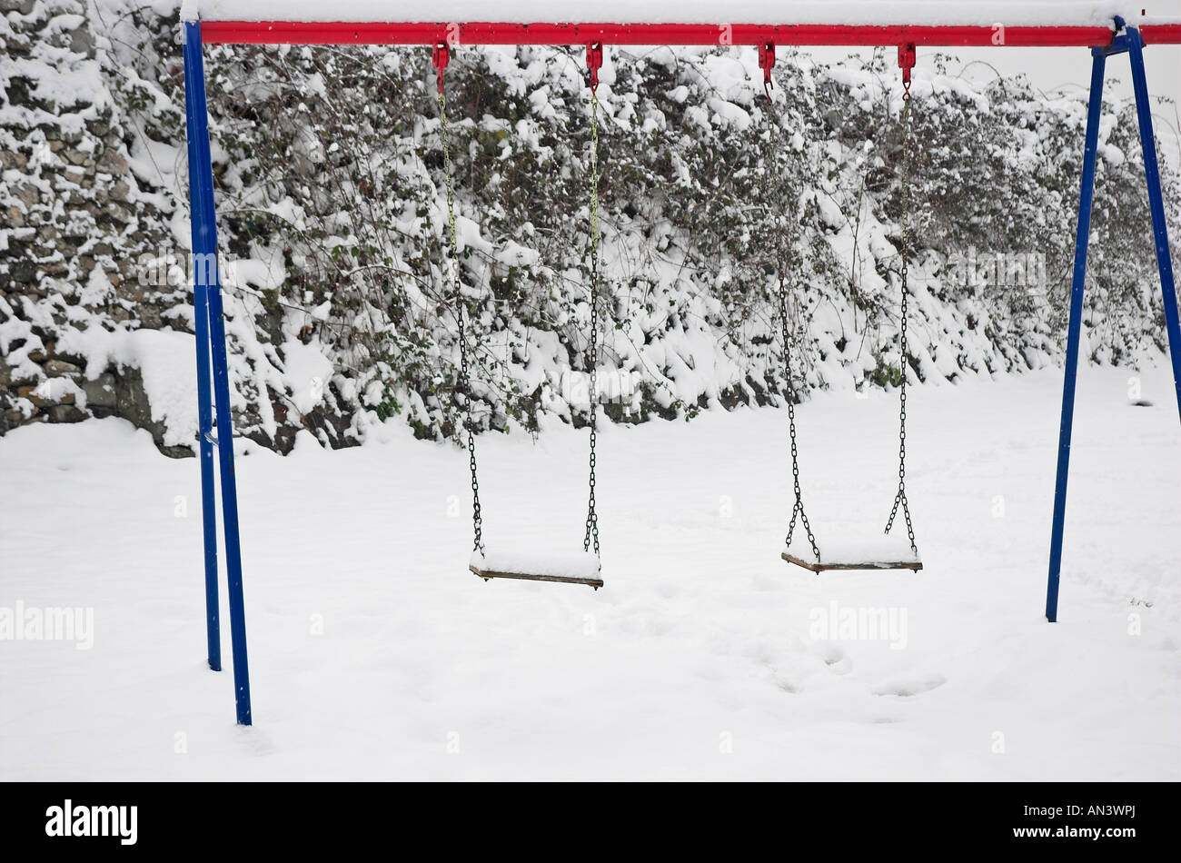 Swings covered in snow Stock Photo - Alamy