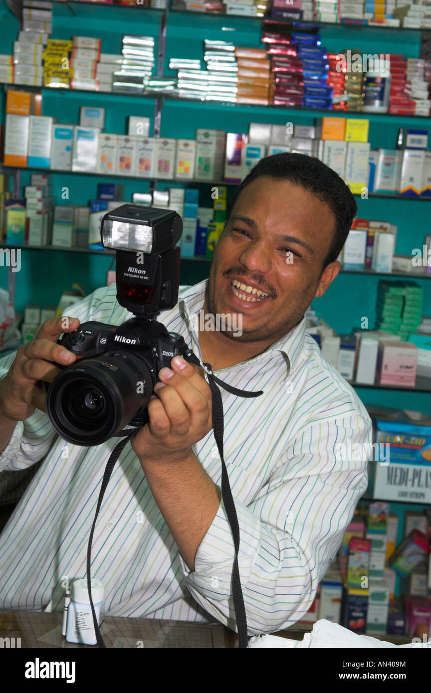 Smiling Egyptian man in shop holding camera Stock Photo - Alamy