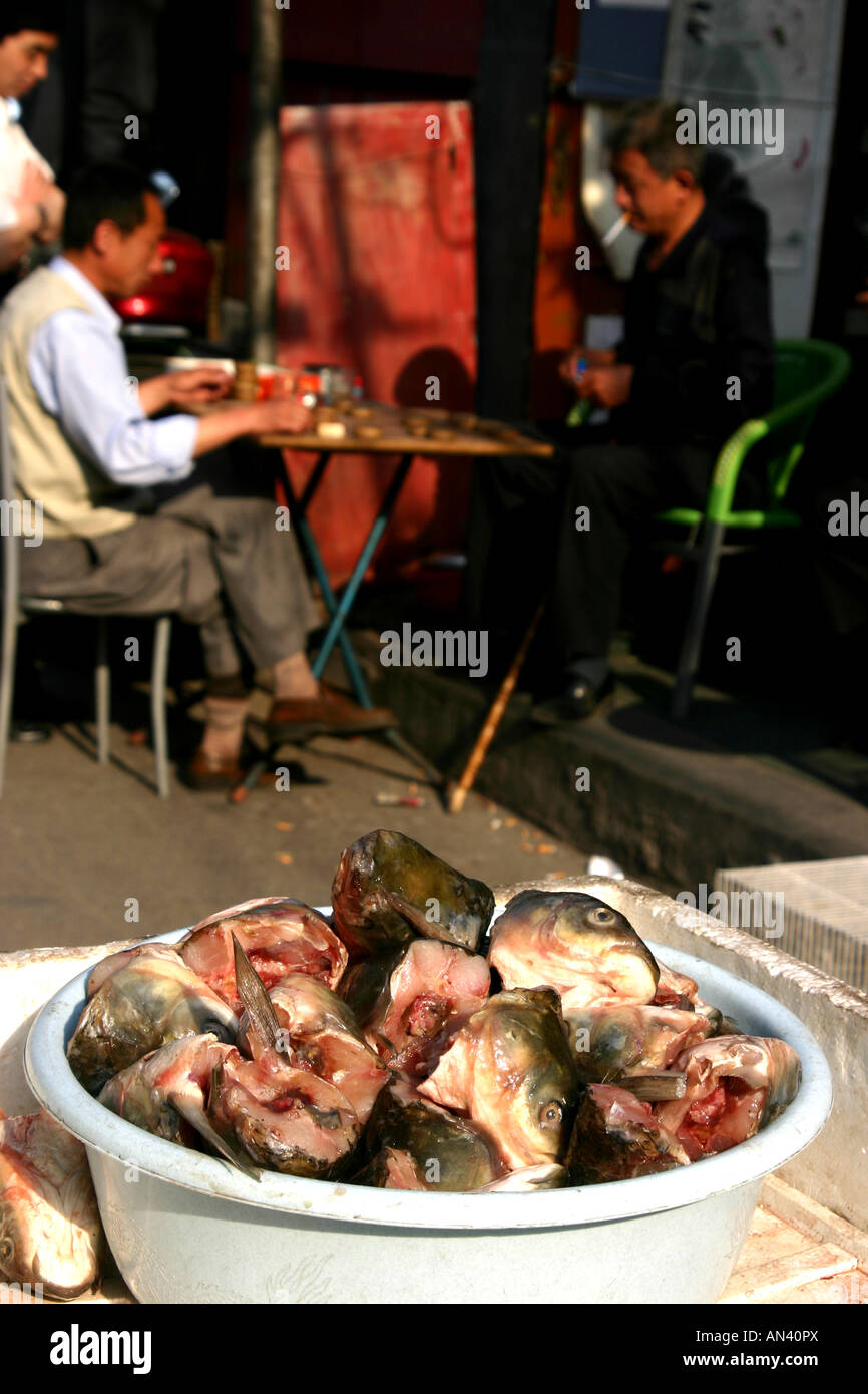 Fish heads waiting to be cooked on a side street in Beijing, China ...