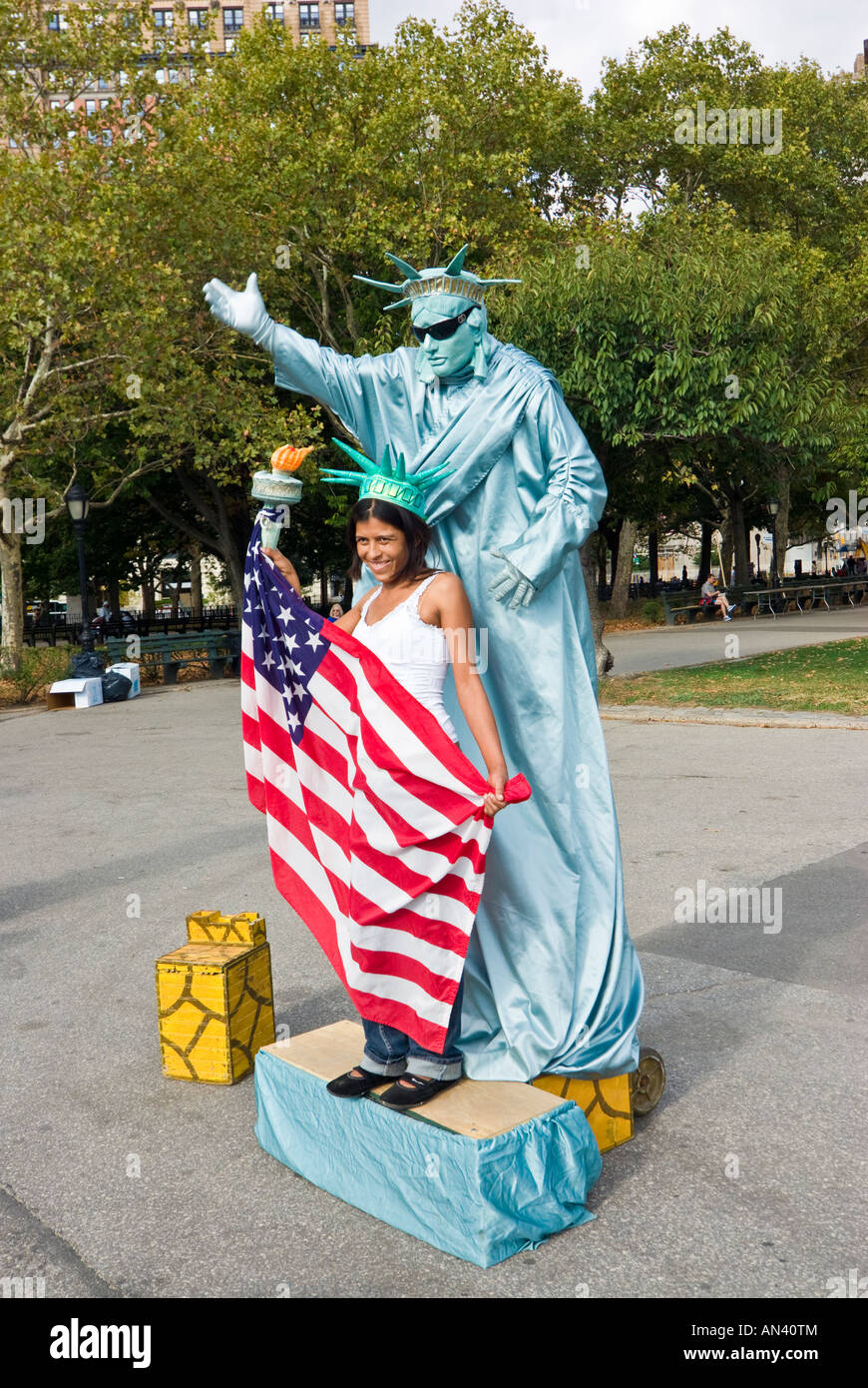 tourist posing with man in Statue of Liberty costume, Battery Park ...