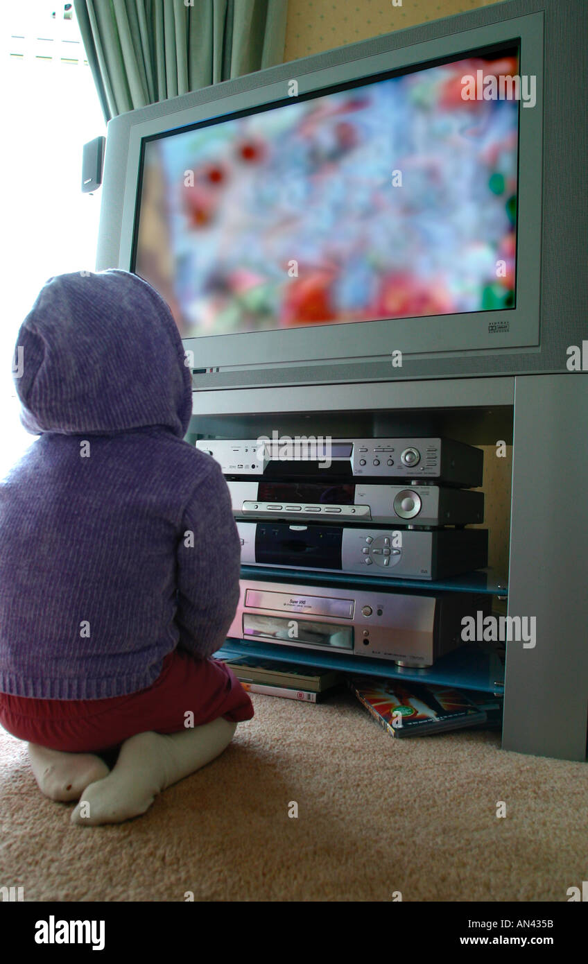 Girl toddler absorbed in watching television Stock Photo - Alamy