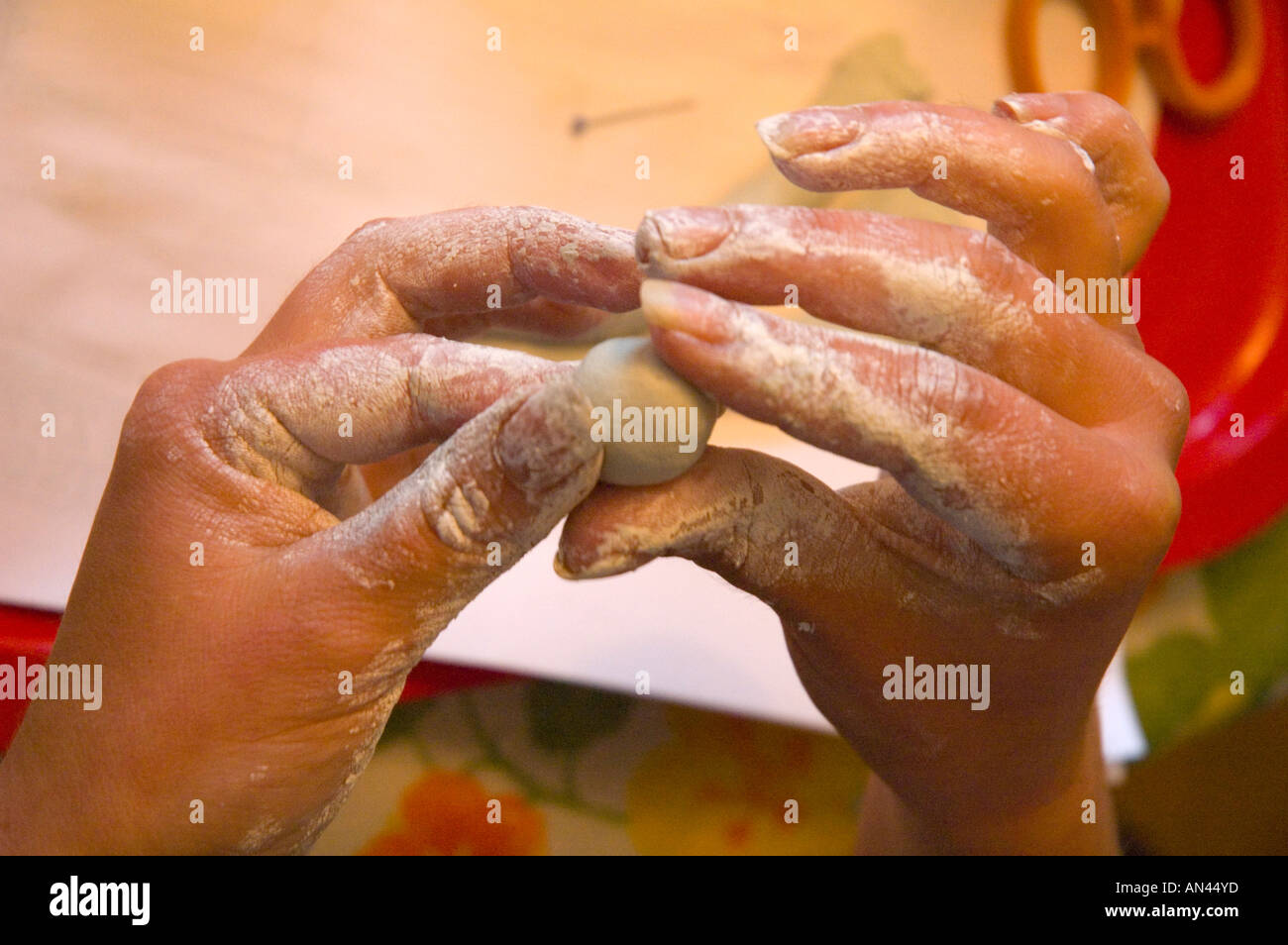 Hands modelling a ball of clay Stock Photo - Alamy