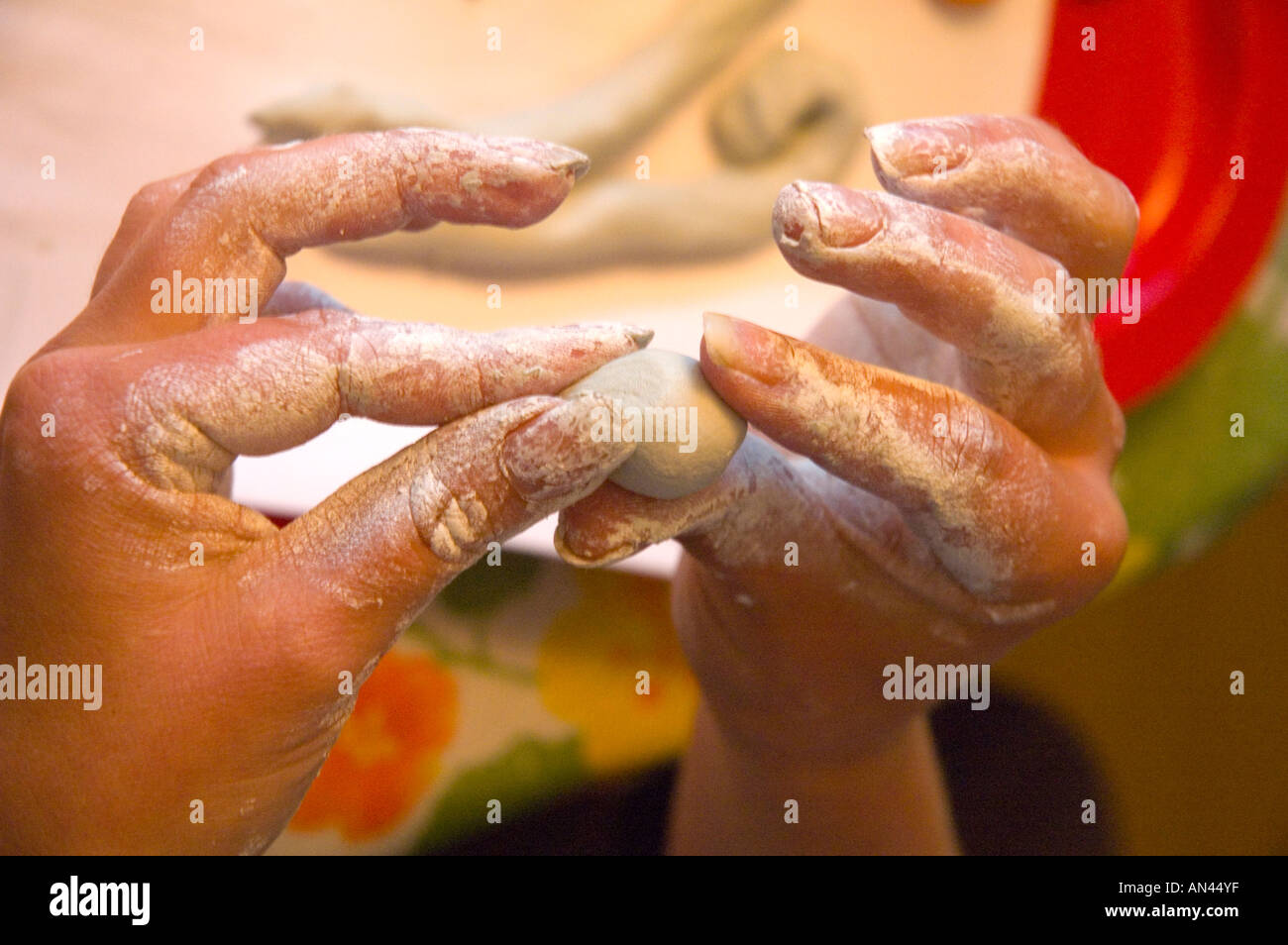 Hands modelling a ball of clay Stock Photo - Alamy