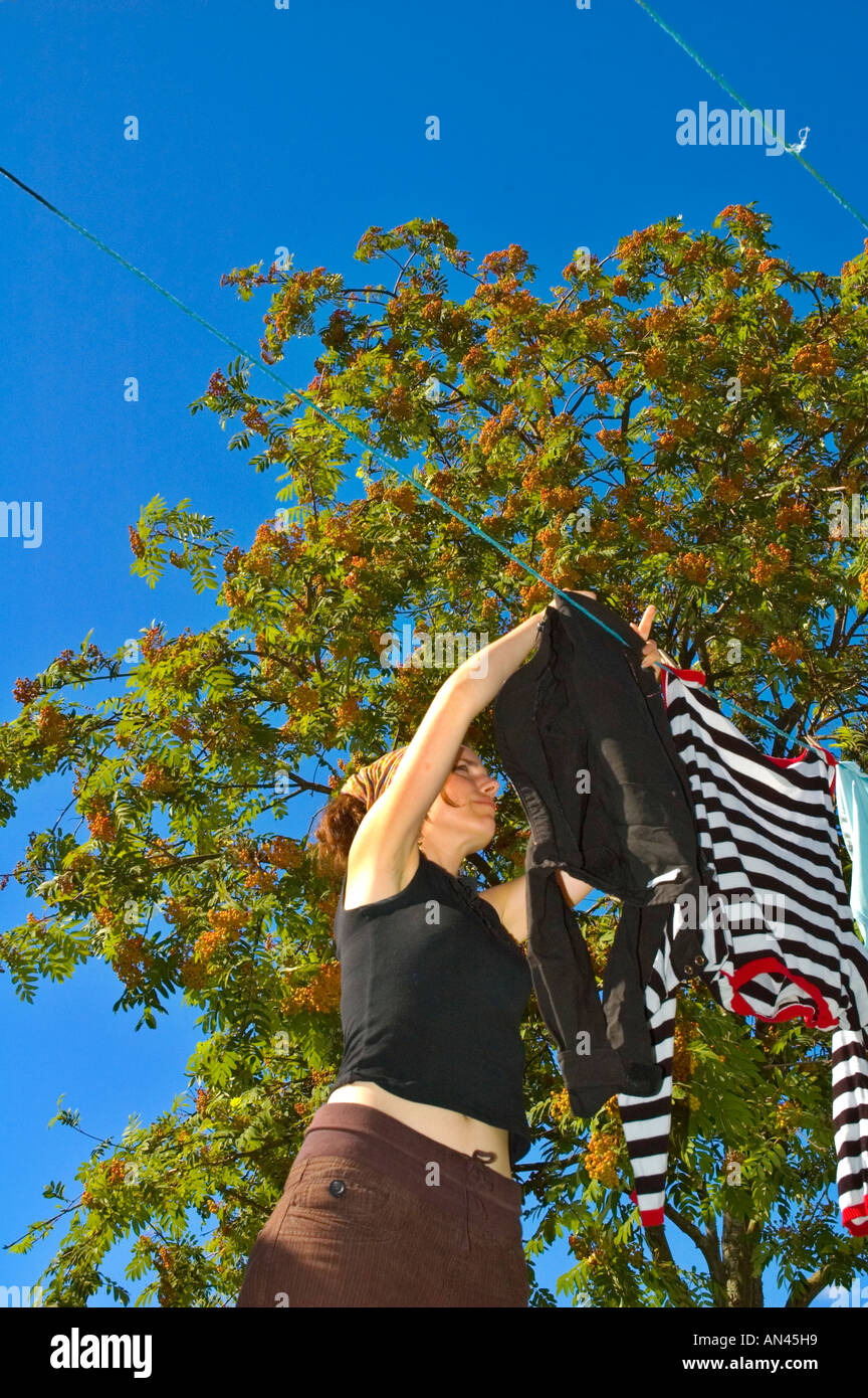 Hanging clothes on a line with a rowan tree as a background Stock Photo ...