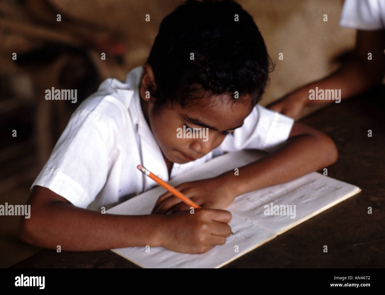 Schoolboy writing in exercise book Vavau Tonga Stock Photo - Alamy