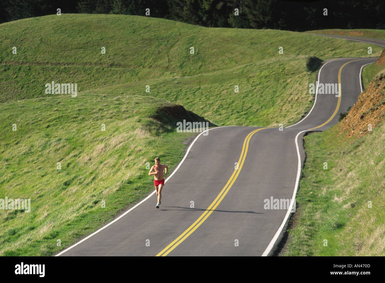 Lonely runner on road hi-res stock photography and images - Alamy