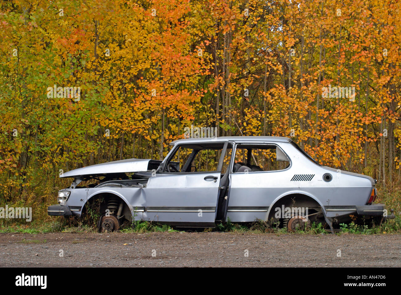 Isolated abandoned , stripped and wrecked car ( Saab 99 ) , Finland ...