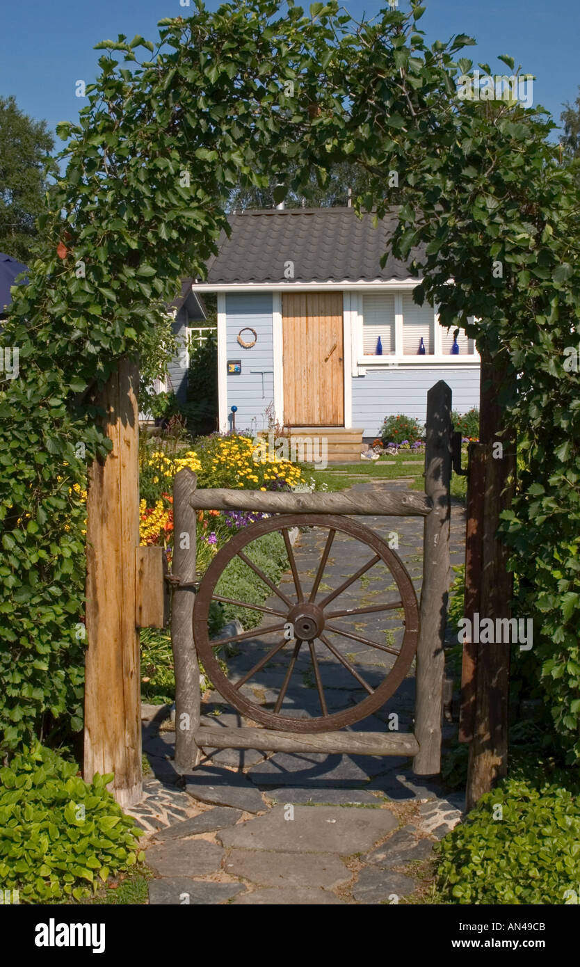 Garden gate and small wooden cottage at a Finnish allotment area ...