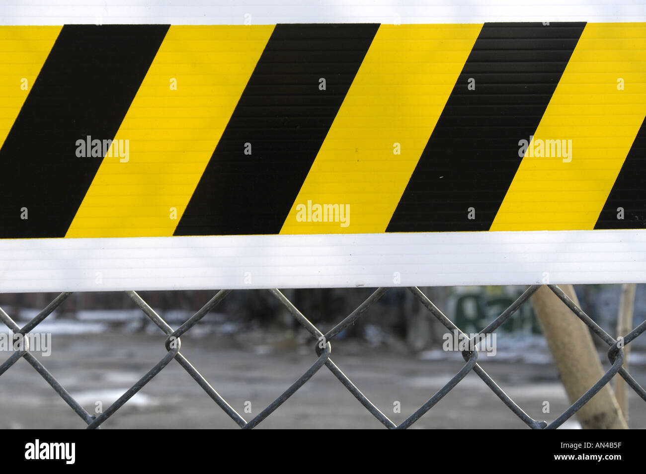 Yellow and black striped road sign with metal wires Stock Photo - Alamy