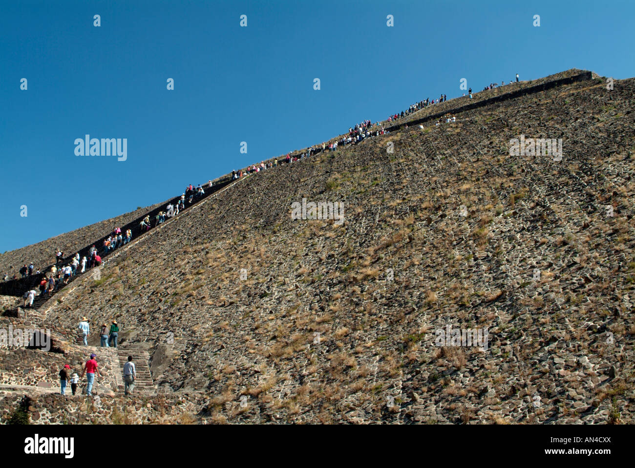 Long line of tourists climbing the Pyramid of the sun at the ancient ...