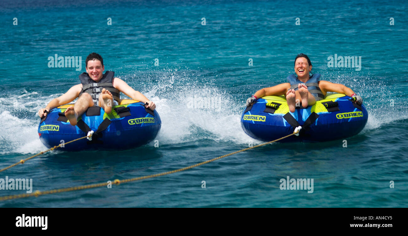 Boy And Girl Enjoy Ring Ride Pulled By Speed Boat Barbados WI Stock ...