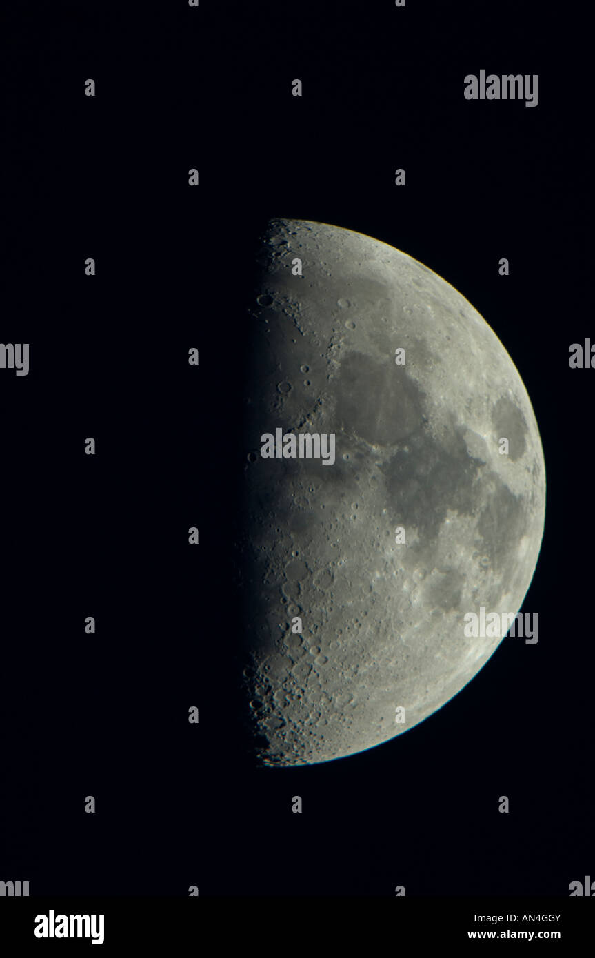 A half moon floats in the night sky Stock Photo - Alamy