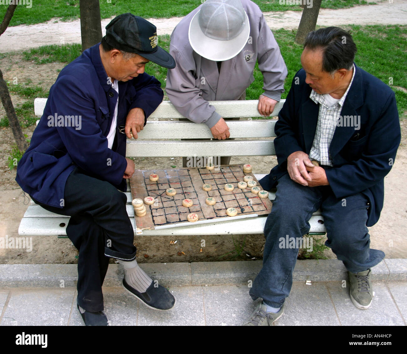 Three men playing Chinese Chess in a Park in Beijing, China Stock Photo ...