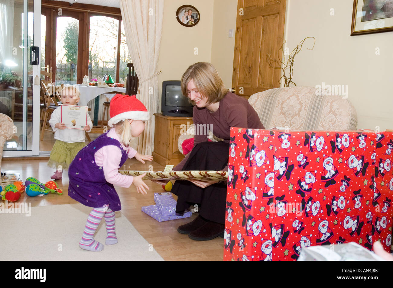 Toddlers giving out Christmas presents Stock Photo - Alamy