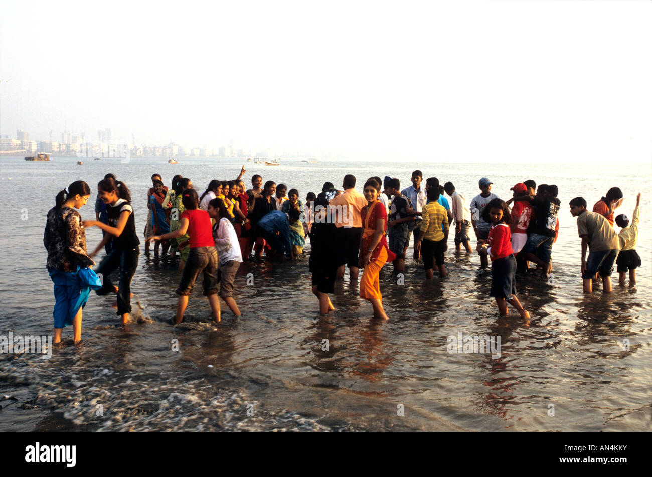 Group of young people playing in the water Stock Photo - Alamy