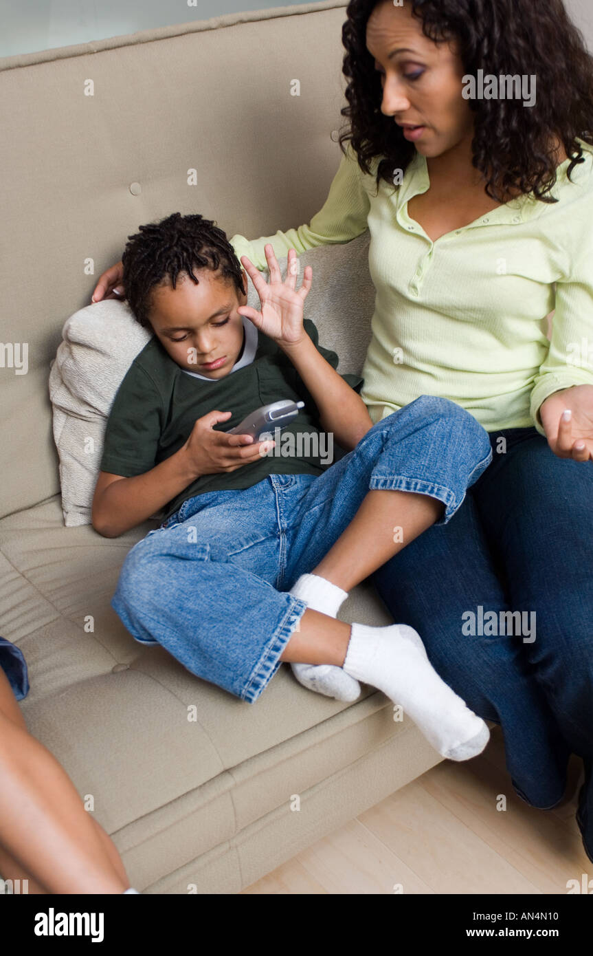 Portrait of boy on the phone ignoring his mom Stock Photo - Alamy