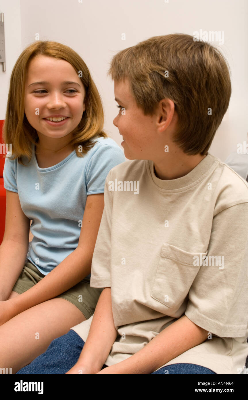 Two young kids talking and laughing with each other Stock Photo - Alamy